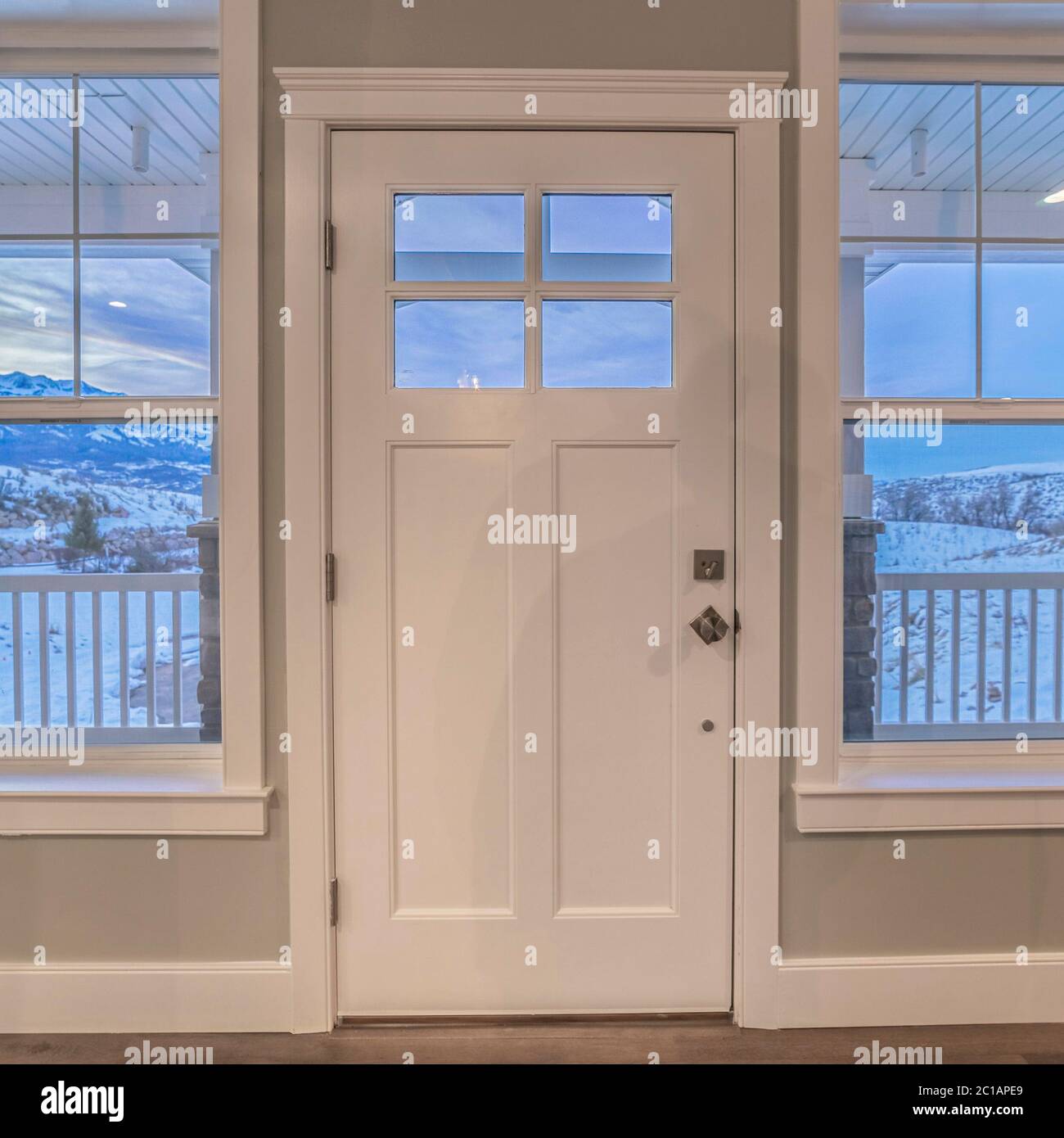 Square crop White front door flanked by windows interior Stock Photo ...