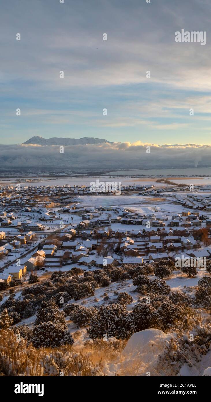 Vertical Snowy winter view of Utah Valley with homes mountain and lake ...