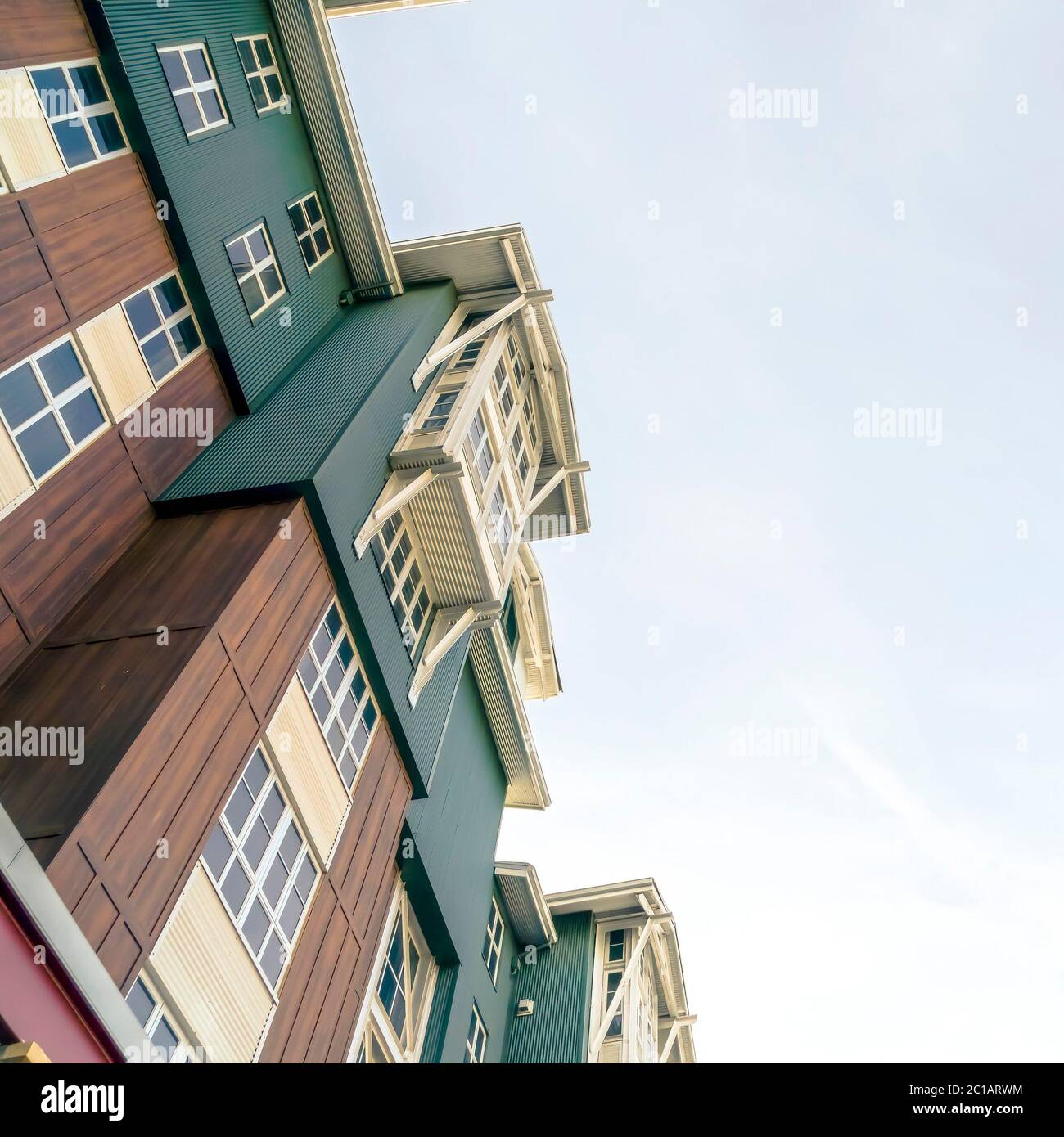 Square Residential building exterior viewed from below with cloudy sky ...