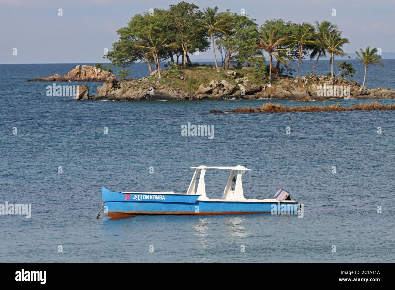 View of boat and small islet from beach, Ampangorinana Village, Nosy ...