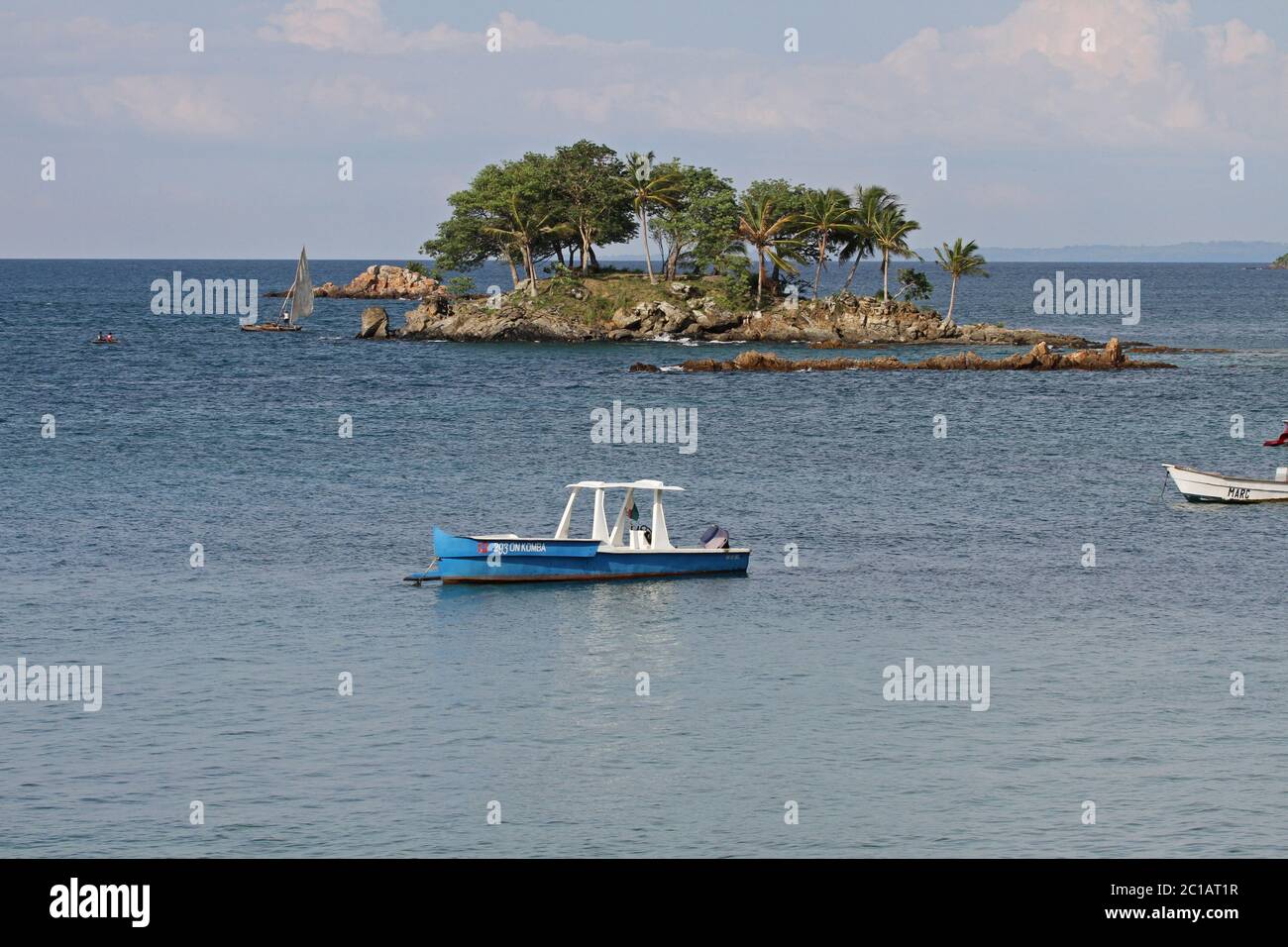 View of boats and small islet from beach, Ampangorinana Village, Nosy ...