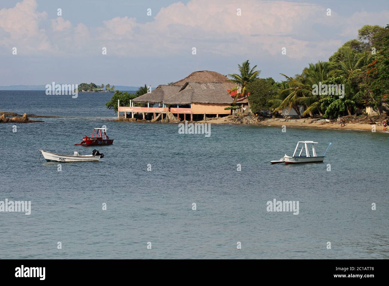 View of boats and small islet from beach, Ampangorinana Village, Nosy ...