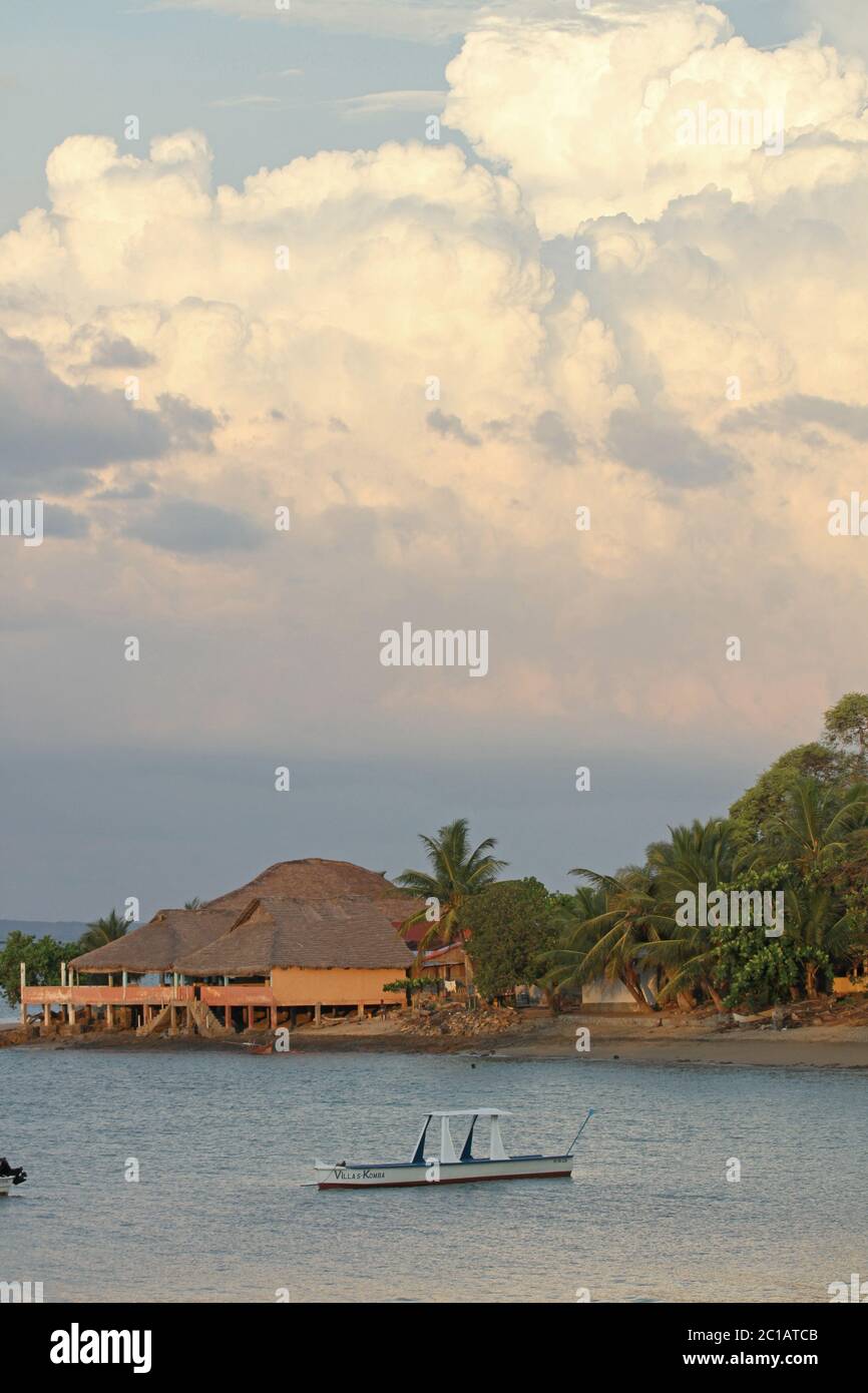 View of boats and thatch lapa from beach, Ampangorinana Village, Nosy ...