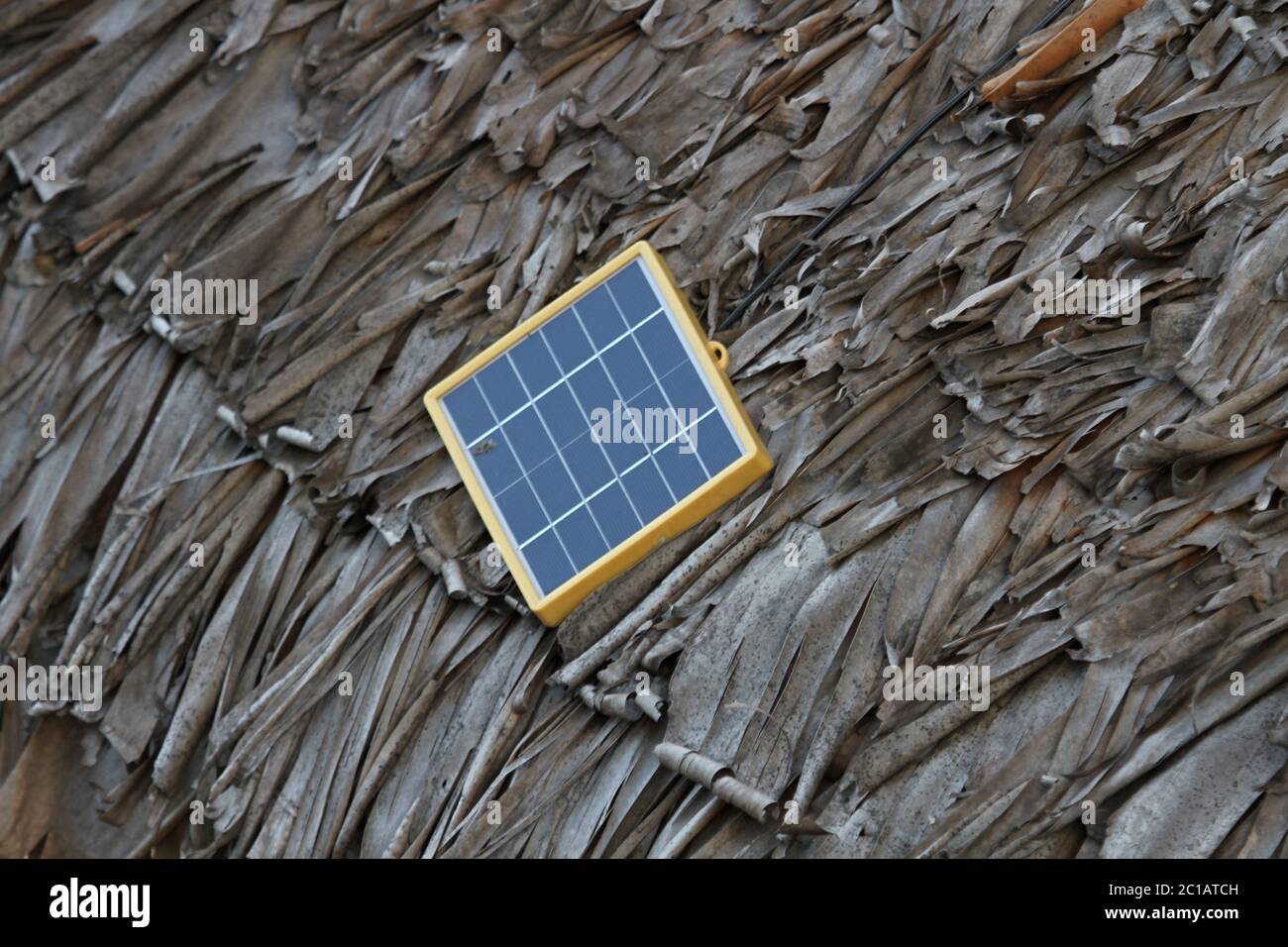 Solar panel on traditional palm thatch roof, Ampangorinana Village ...