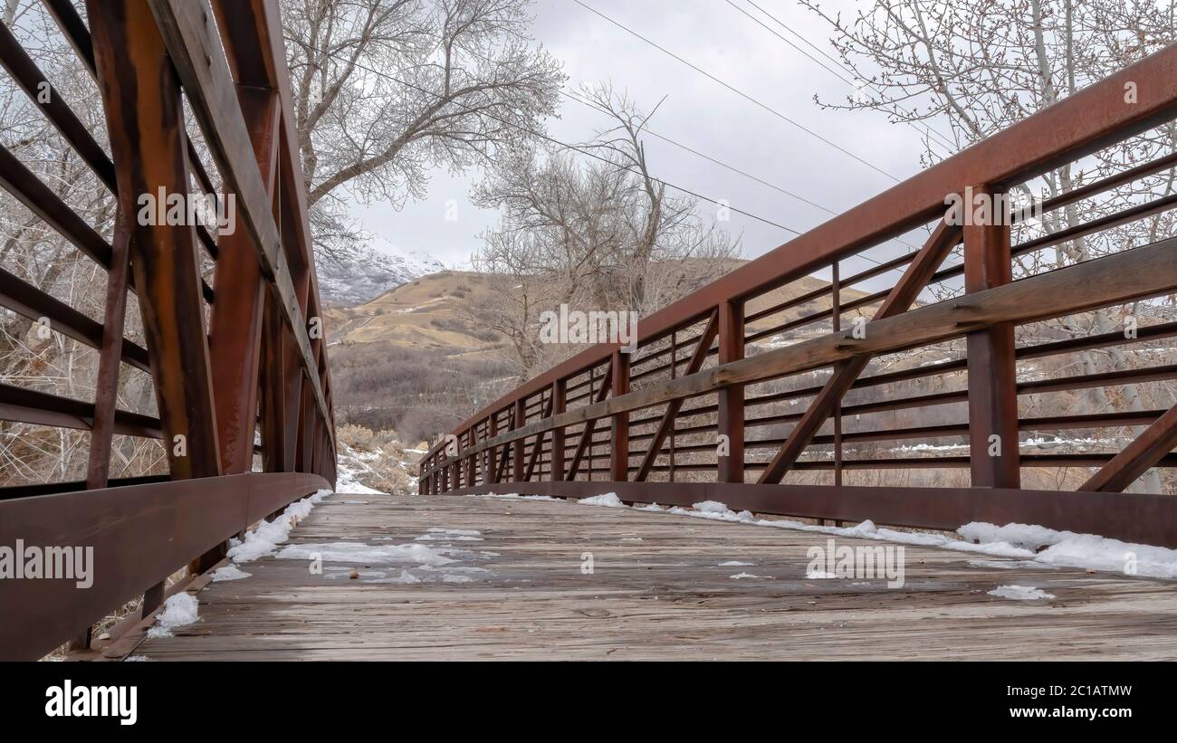 Panorama Bridge with metal railing and melting snow on the wooden ...