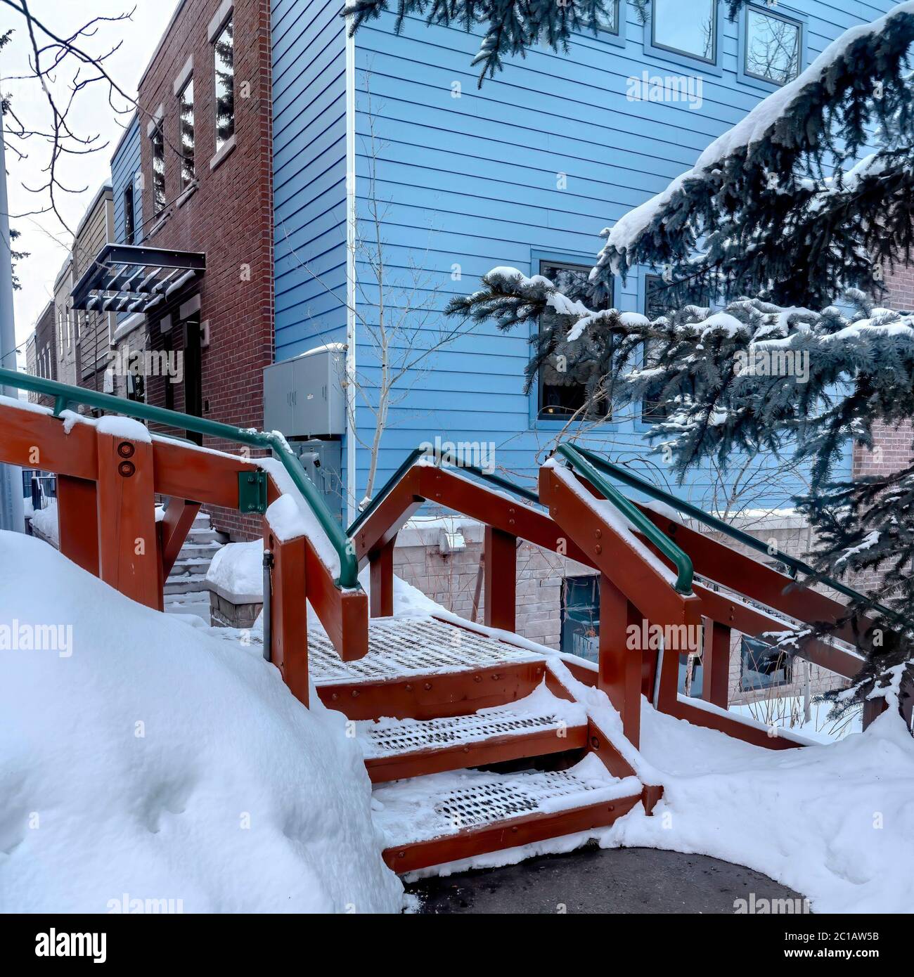Square Oudoor stairs with grate metal treads and green handrails ...