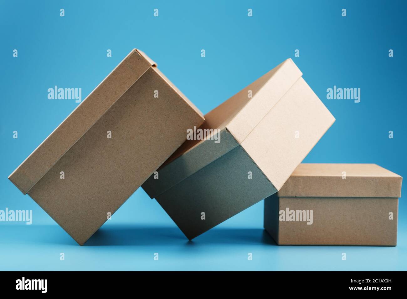 Cardboard boxes spread out on a blue background, free space Stock Photo ...