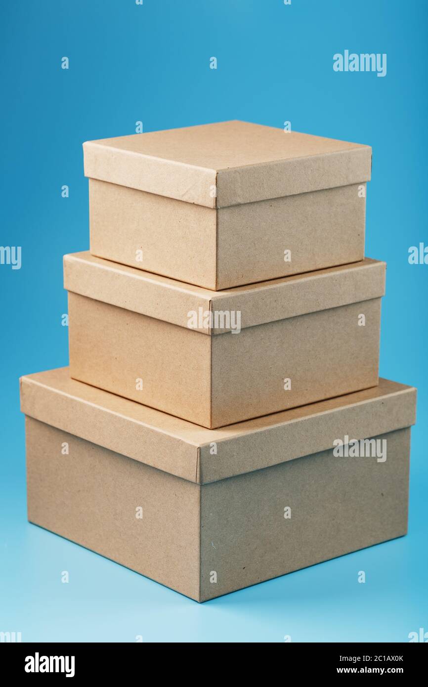 Cardboard boxes spread out on a blue background, free space Stock Photo ...