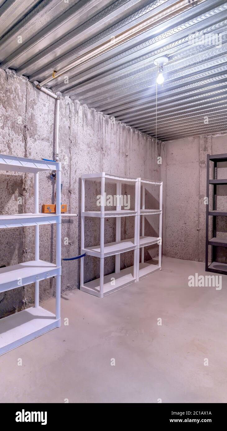 Vertical Empty multi layer metal racks inside a storage room with ...