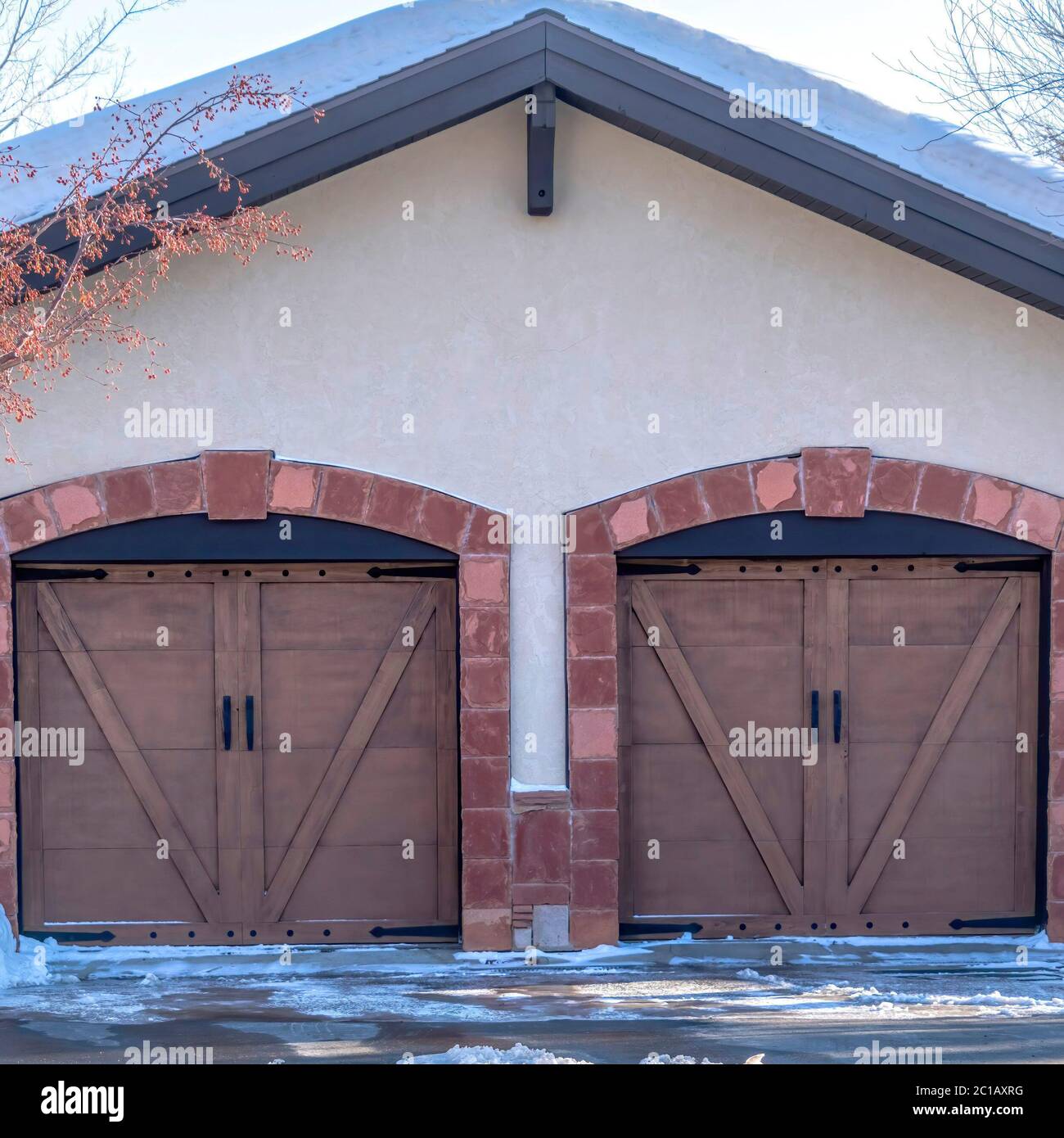 Square crop Facade of a residential garage with gable roof and two ...