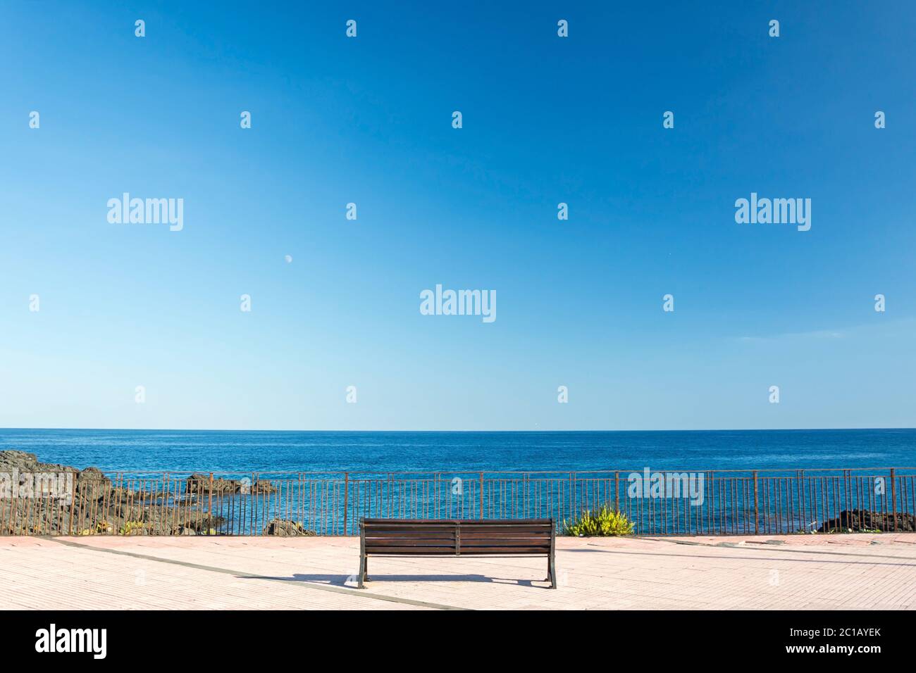 Lonely bench facing beautiful ocean panorama Stock Photo - Alamy
