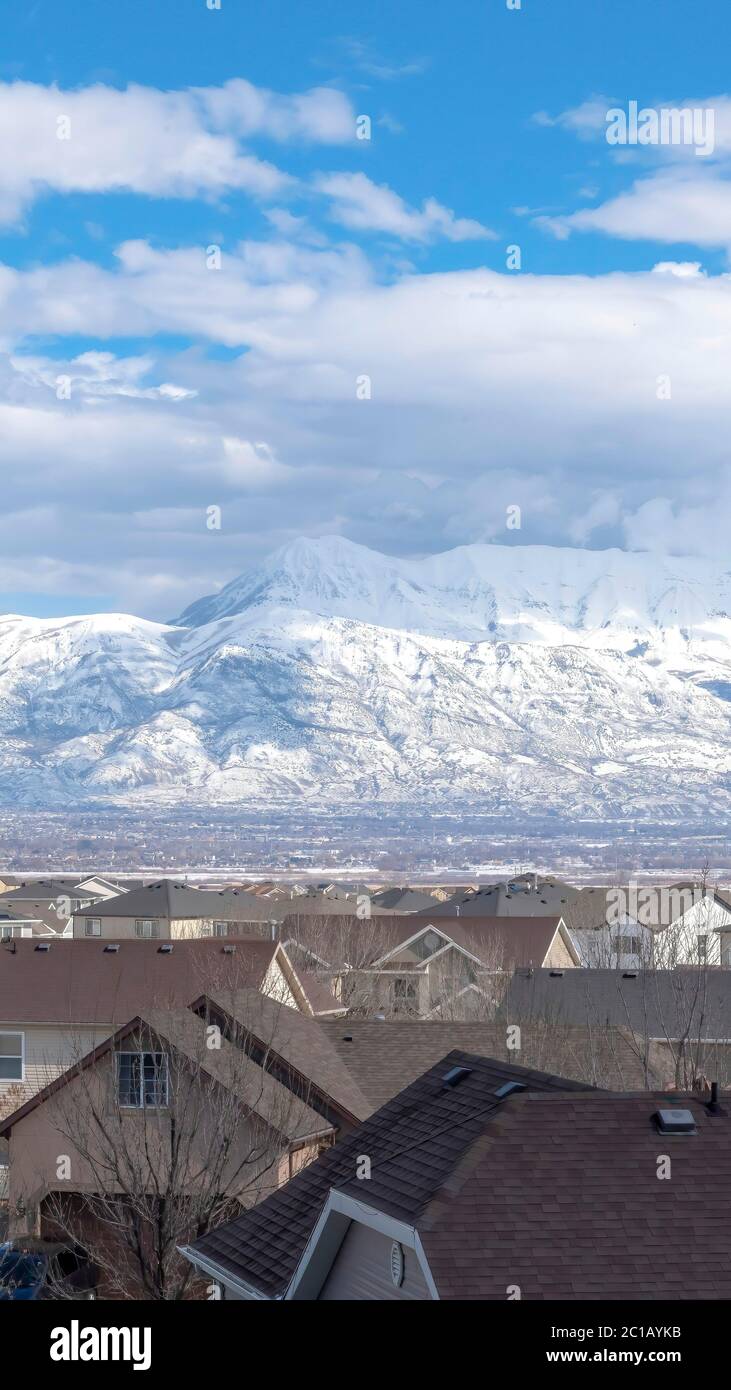Vertical crop Homes on a scenic community with view of frosted snowy ...