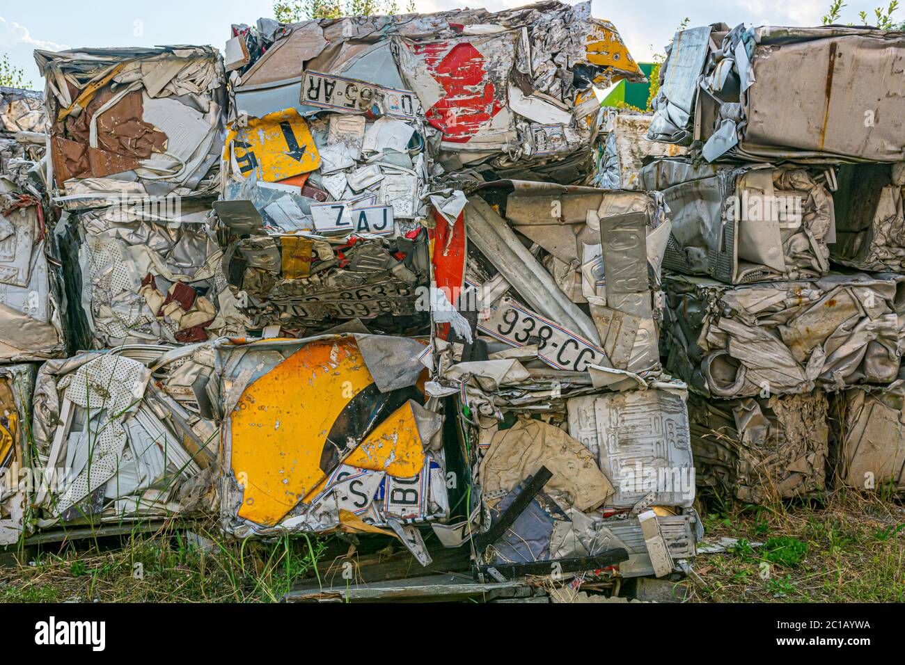 Compressed aluminium scrap in large cubes forming landfill in piles ...