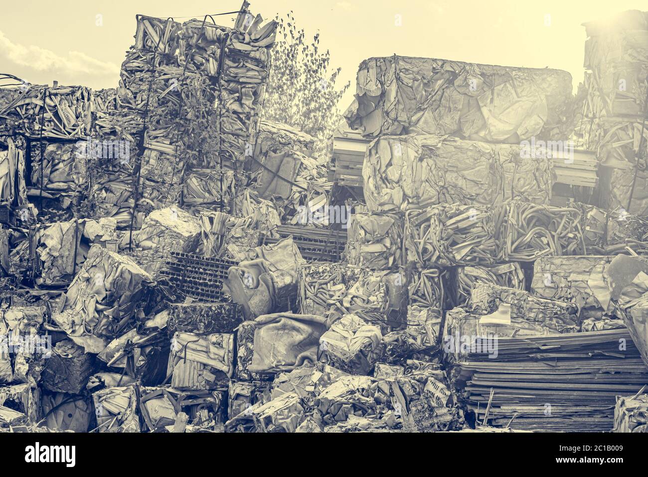 Compressed aluminium scrap in large cubes forming landfill in piles ...
