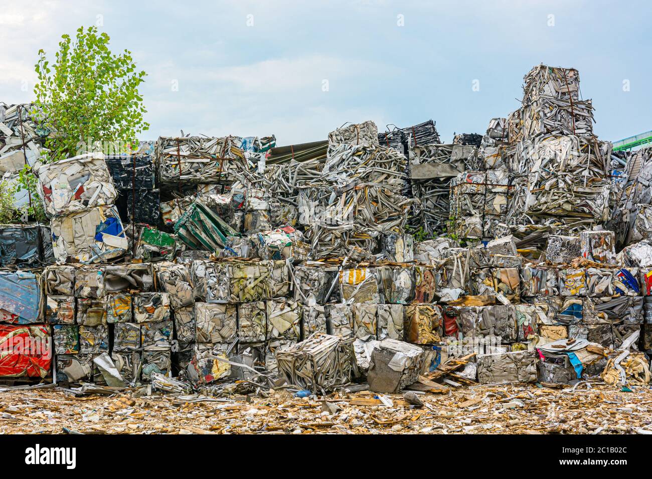 Compressed aluminium scrap in large cubes forming landfill in piles ...