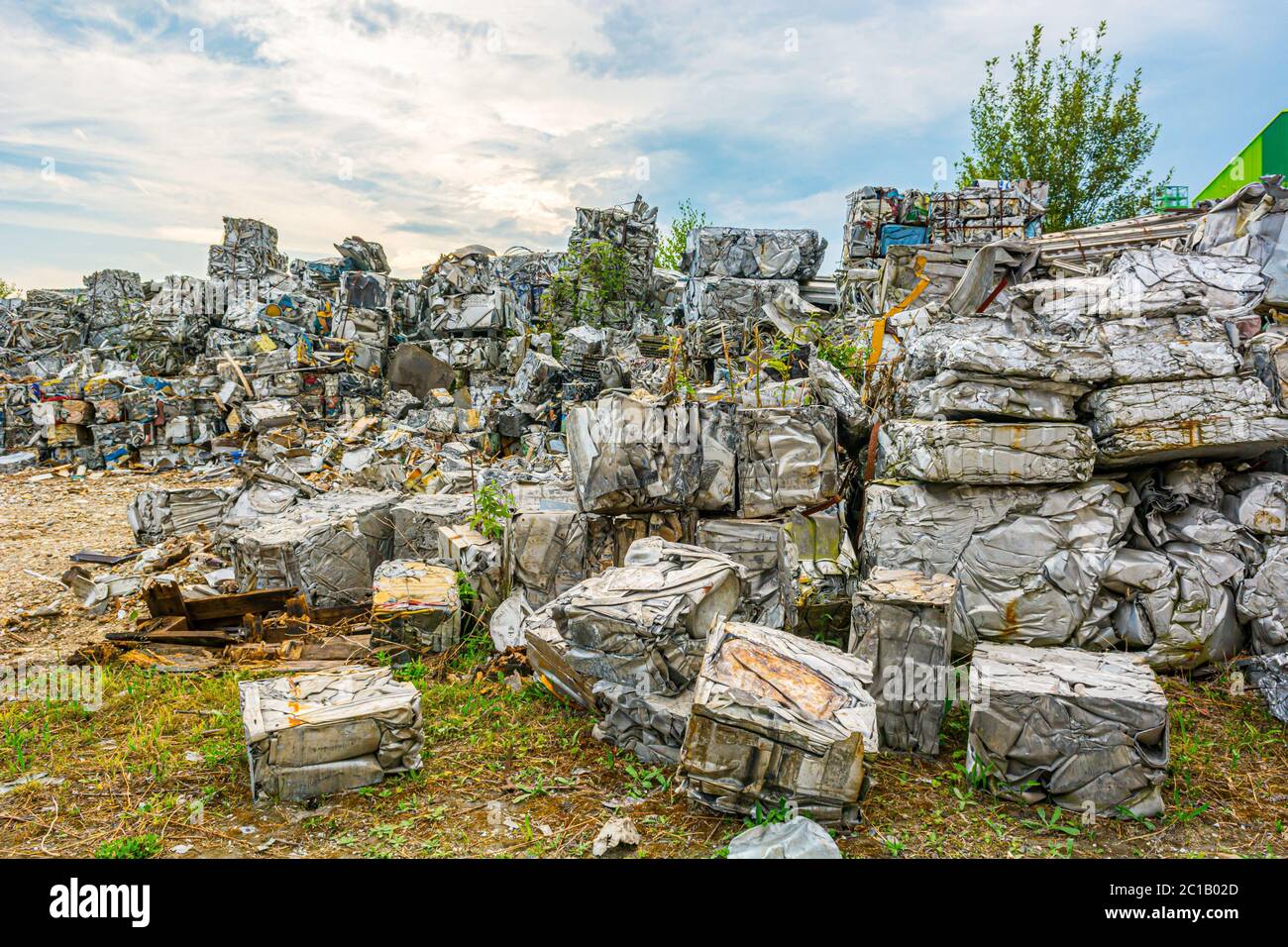 Compressed aluminium scrap in large cubes forming landfill in piles ...