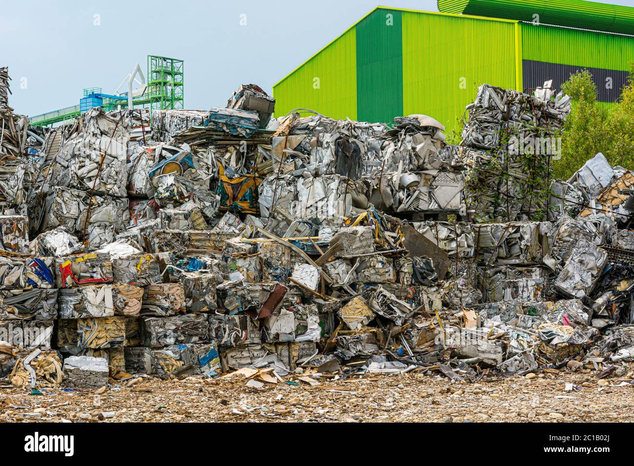 Compressed aluminium scrap in large cubes forming landfill in piles ...