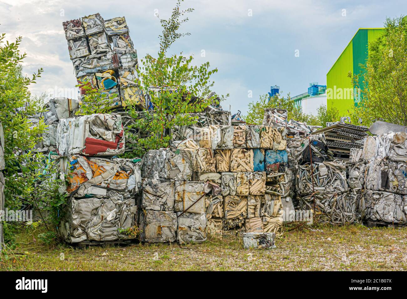 Compressed aluminium scrap in large cubes forming landfill in piles ...