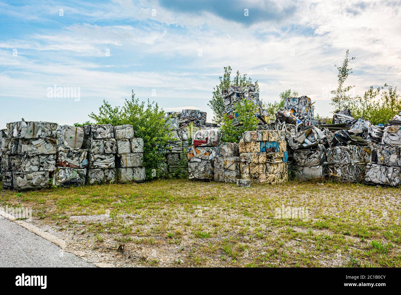 Compressed aluminium scrap in large cubes forming landfill in piles ...