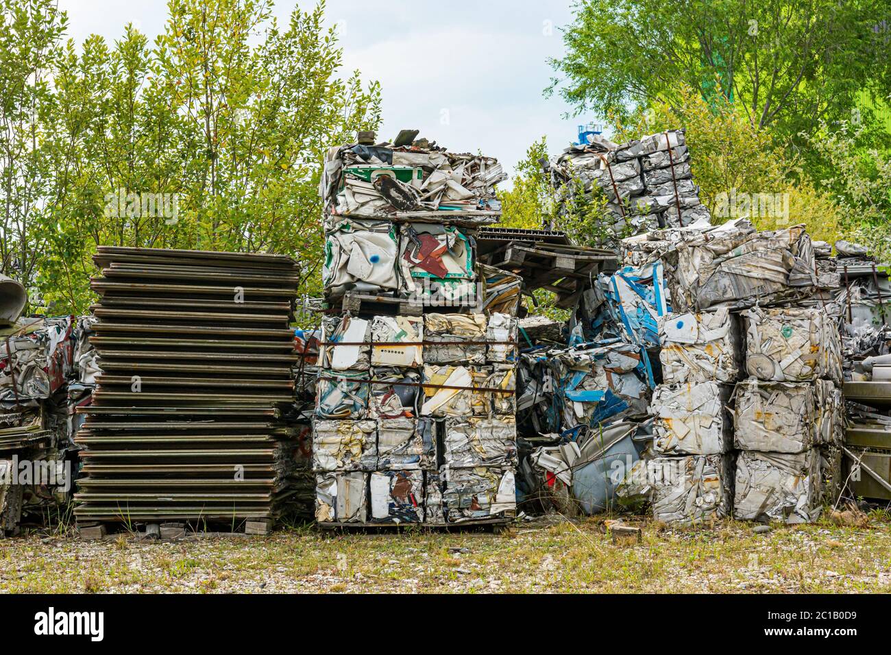 Compressed aluminium scrap in large cubes forming landfill in piles ...