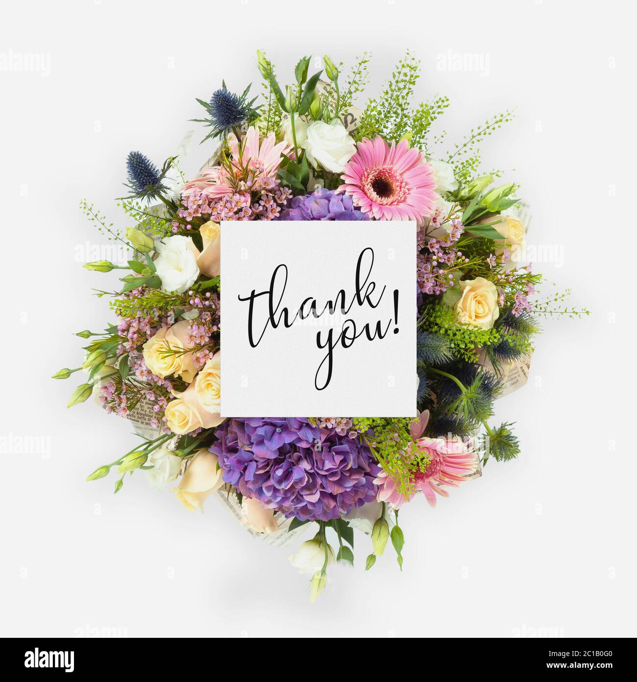 Fresh flowers bunch and card with words thank you written on it Stock ...