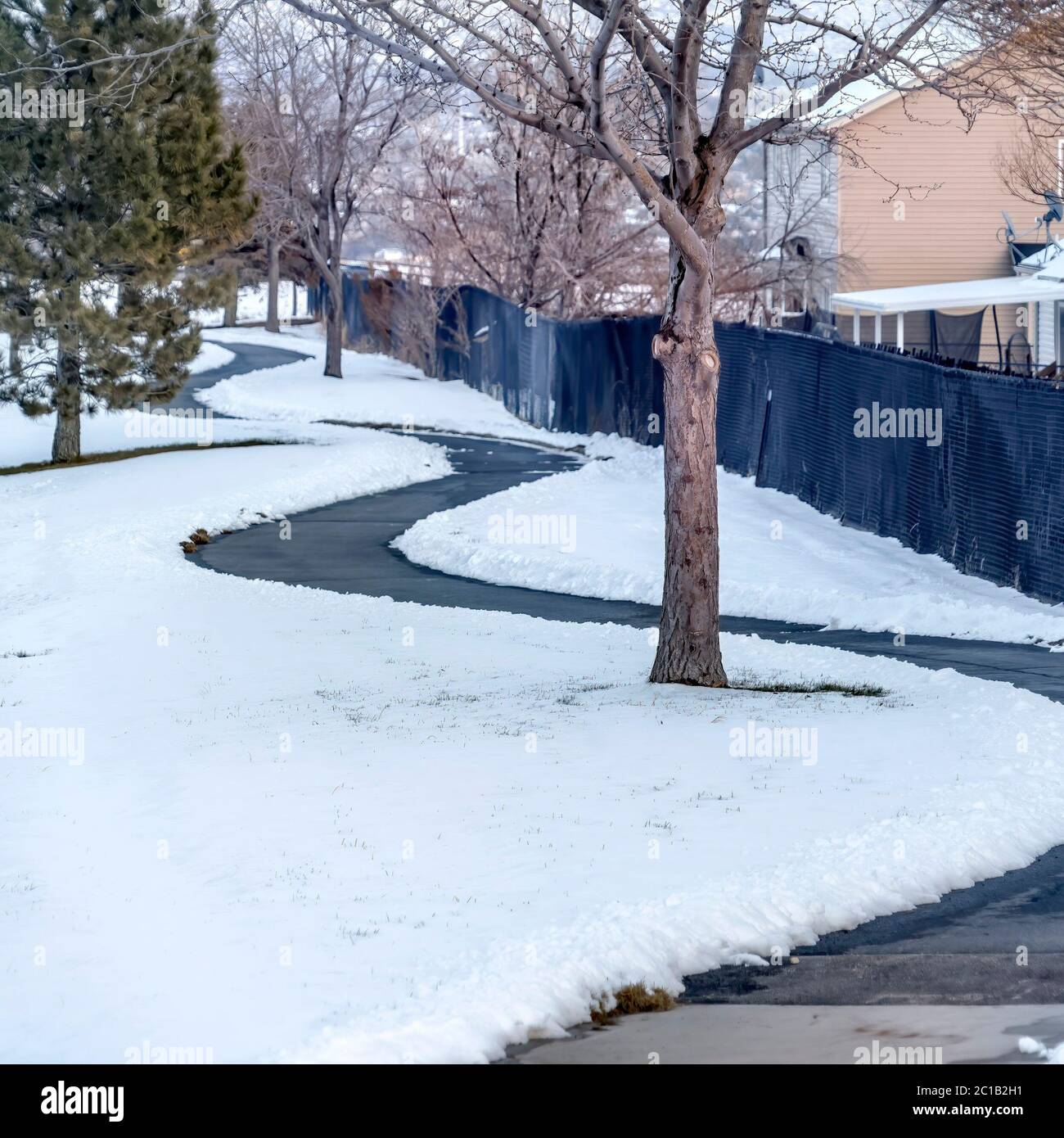 Square frame Curvy narrow road on snow covered ground in winter with ...