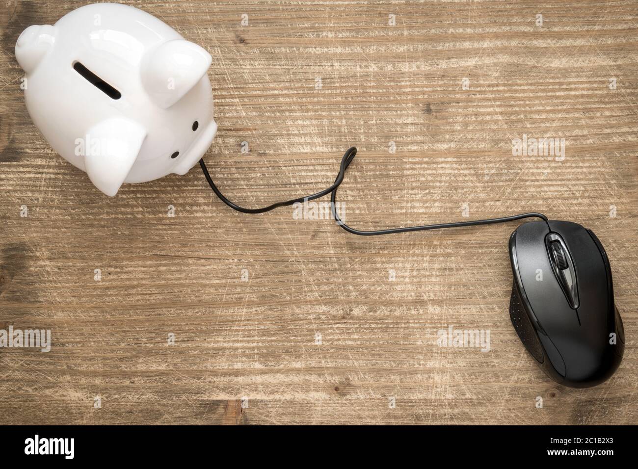Piggy bank with computer mouse Stock Photo - Alamy