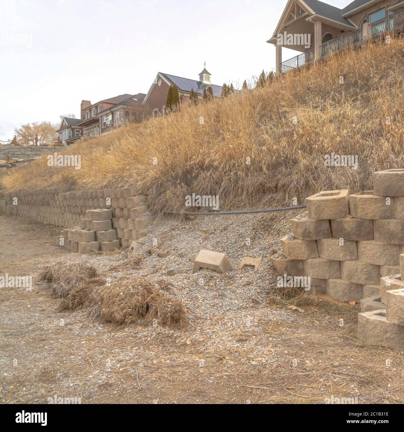 Square frame Damaged stone blocks retaining wall lining a hill with ...