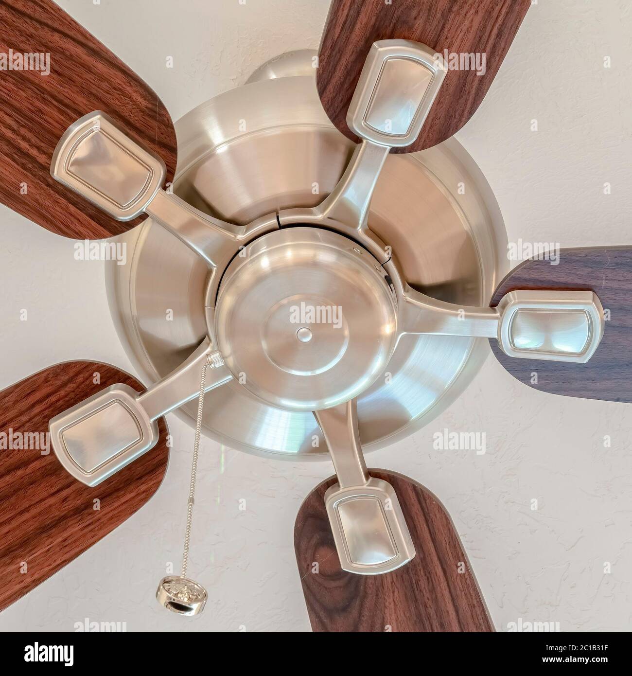 Square crop Ceiling fan with wooden blades and lights mounted on the ...