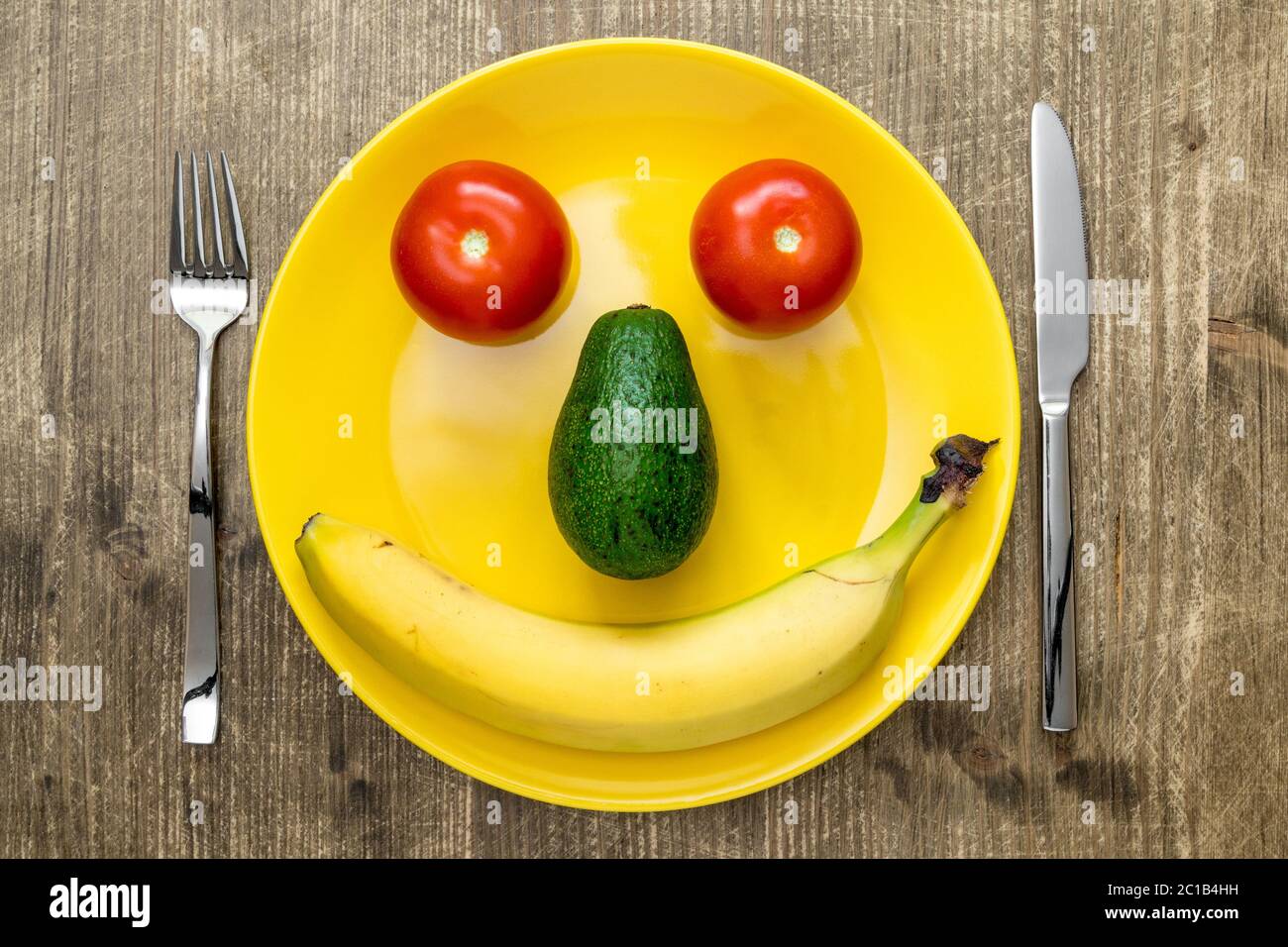 Smiling face from vegetables and fruits on plate Stock Photo - Alamy