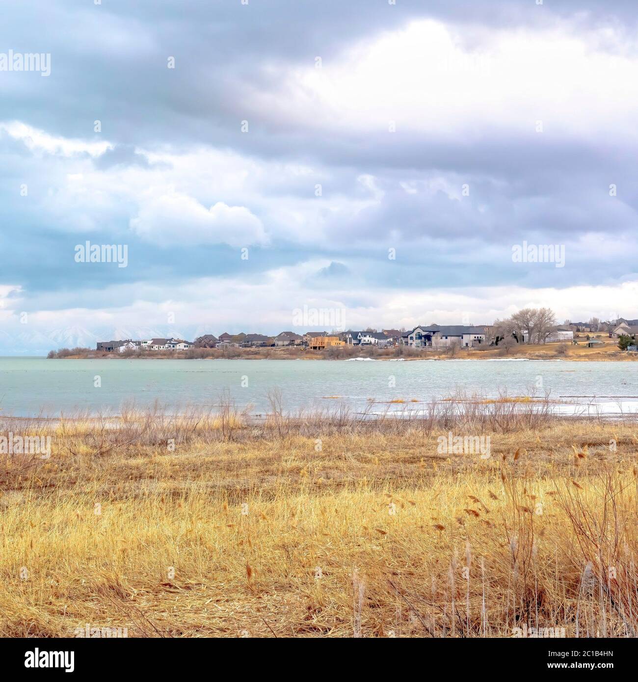 Square Scenic lake landscape with residences by the shore beneath sky ...