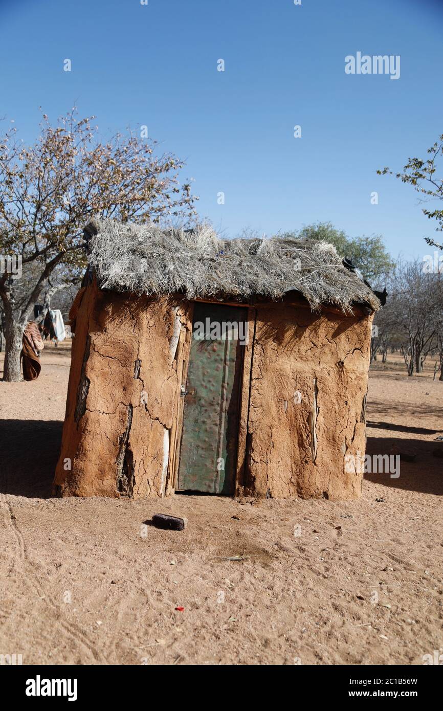 Traditional Himba house in a village. The hut is build from mud and ...