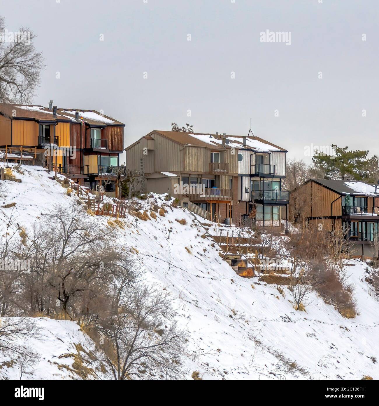 Square crop Homes on a mountain setting against cloudy sky in winter at ...