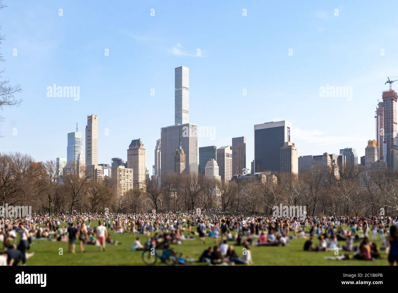 Big crowd of people gathering on the lawn in Central Park with the ...