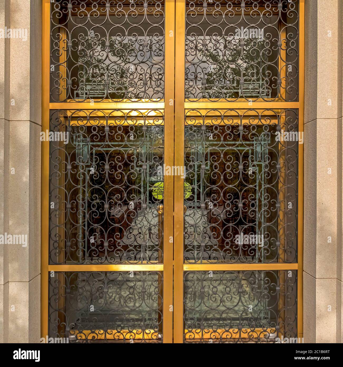 Square crop Decorative wrought iron door with gold frames in front of ...