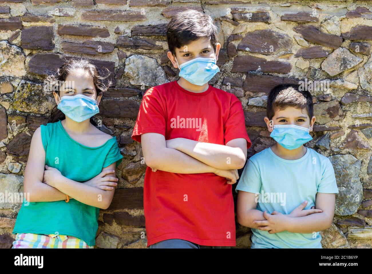 Three little kids with safety masks Stock Photo - Alamy