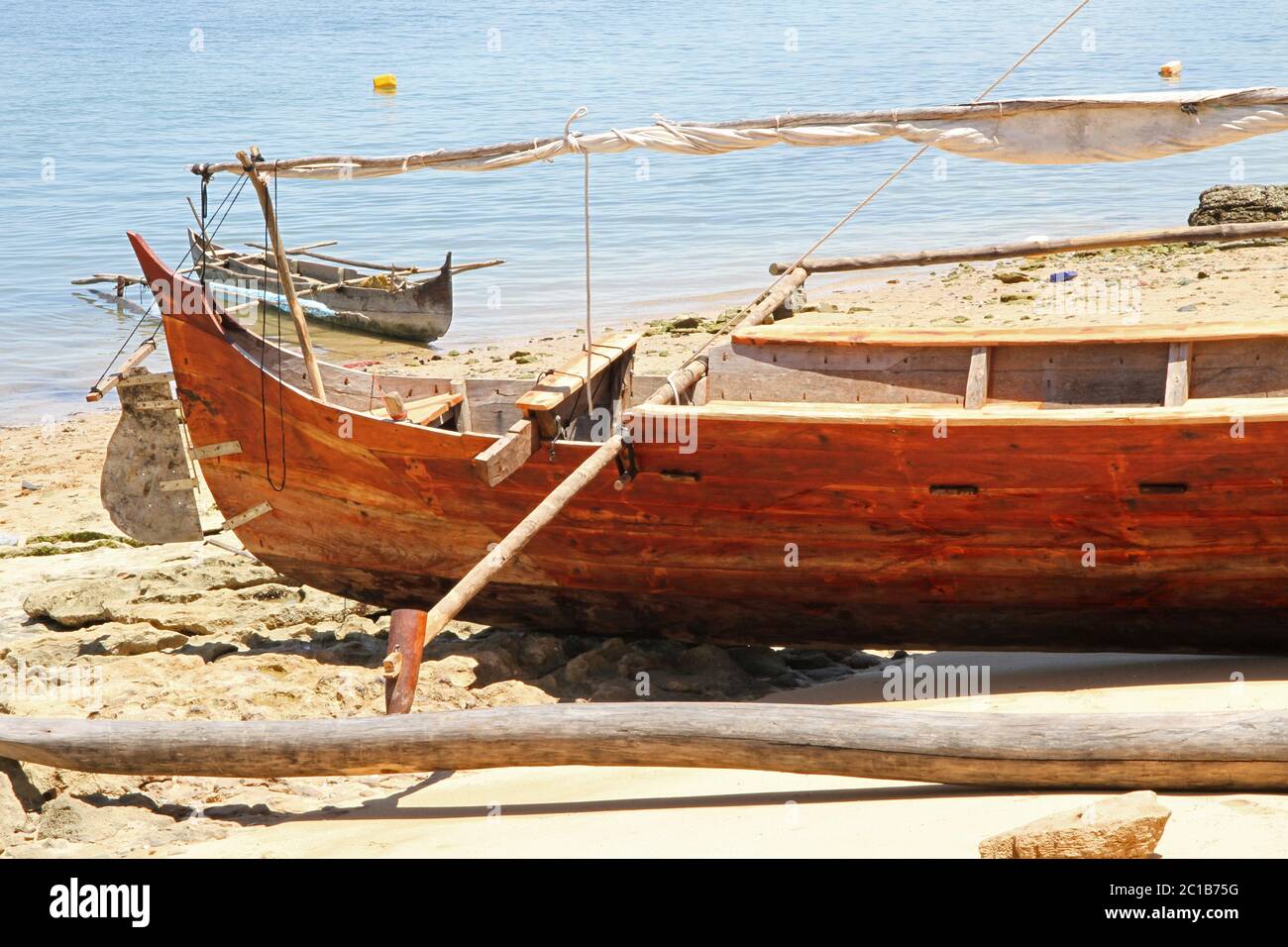 Beached fishing boats on beach, Ampangorinana Village, Nosy Komba ...