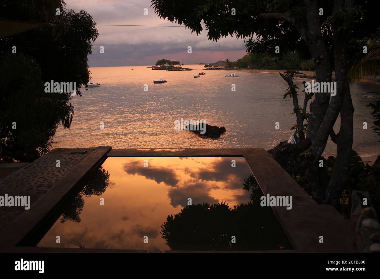 View of ocean and swimming pool at sunset from 293 On Komba Guest House ...