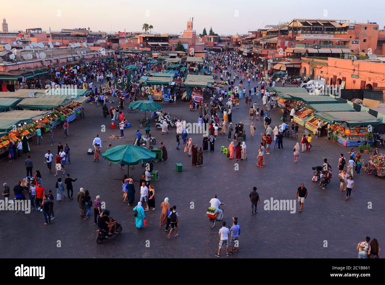 Morocco, Marrakesh. Dusk at Djemaa el Fna Square. At night the square ...