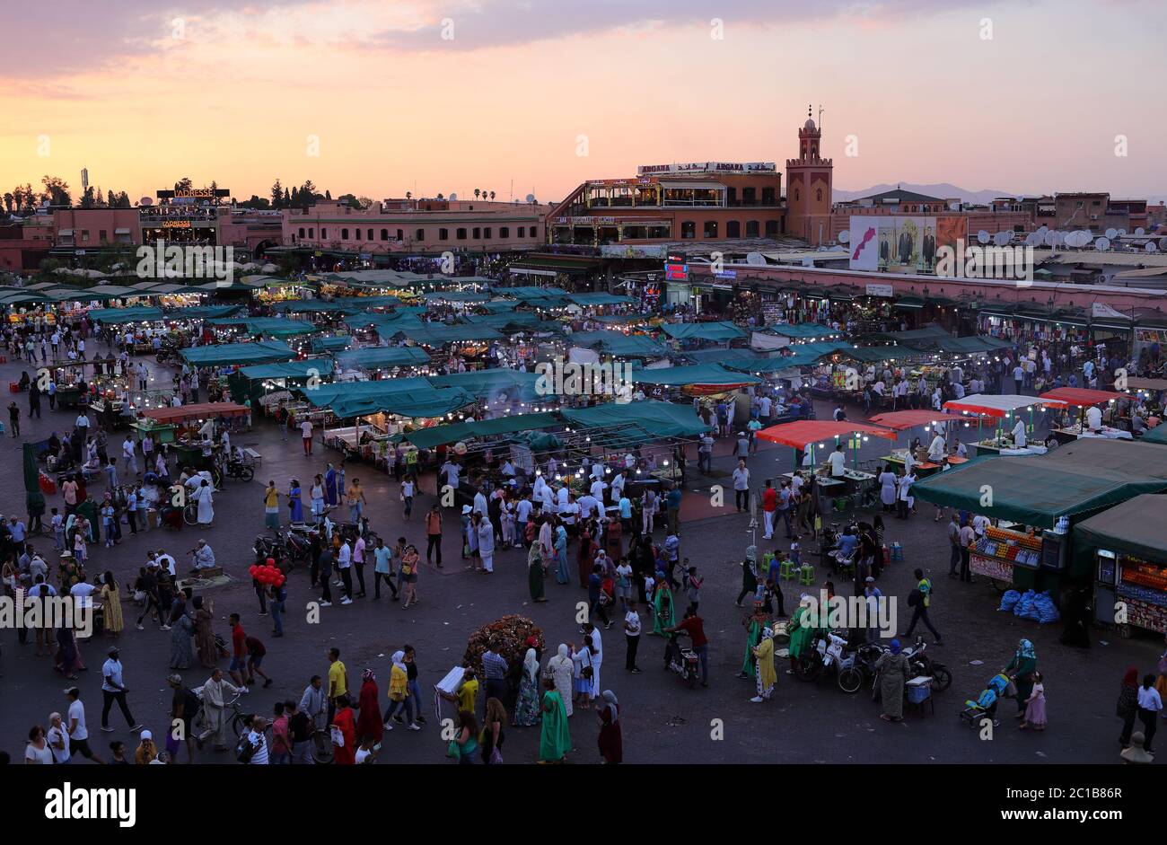 Morocco, Marrakesh. Dusk at Djemaa el Fna Square. At night the square ...