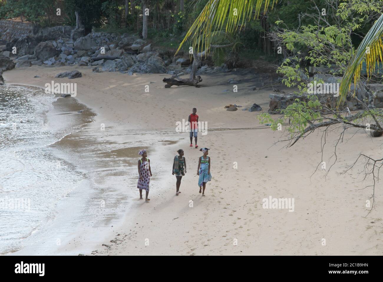 Local villagers walking on the beach, Ampangorinana Village, Nosy Komba ...