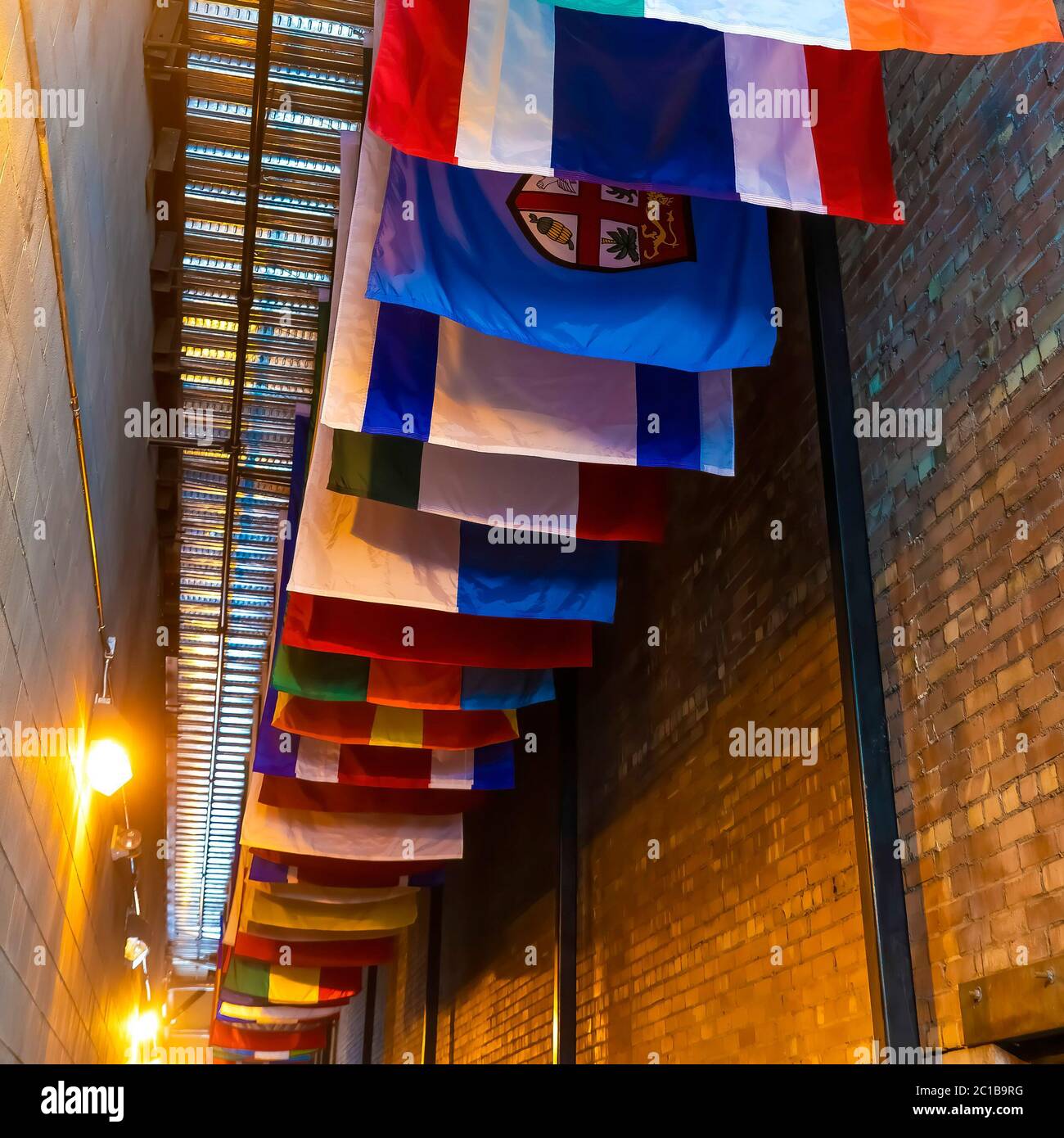 Square crop Vibrant colorful decorative flags against corrugated metal ...