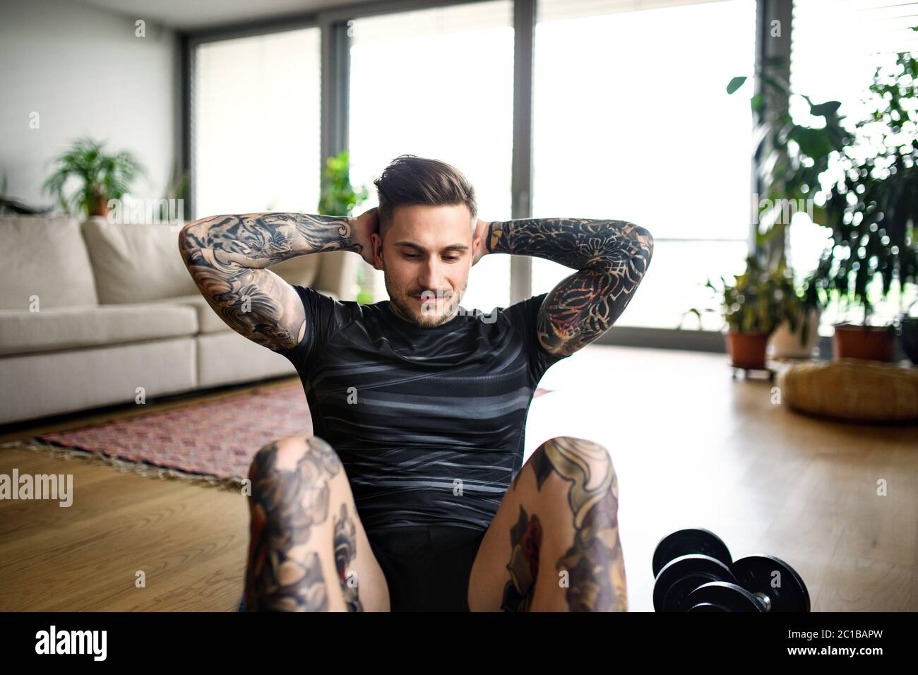 Front view portrait of man doing workout exercise indoors at home Stock ...