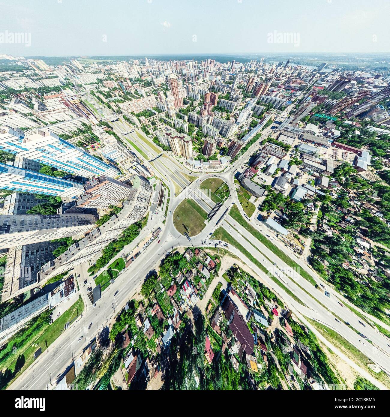 Aerial city view with crossroads and roads, houses, buildings, parks ...
