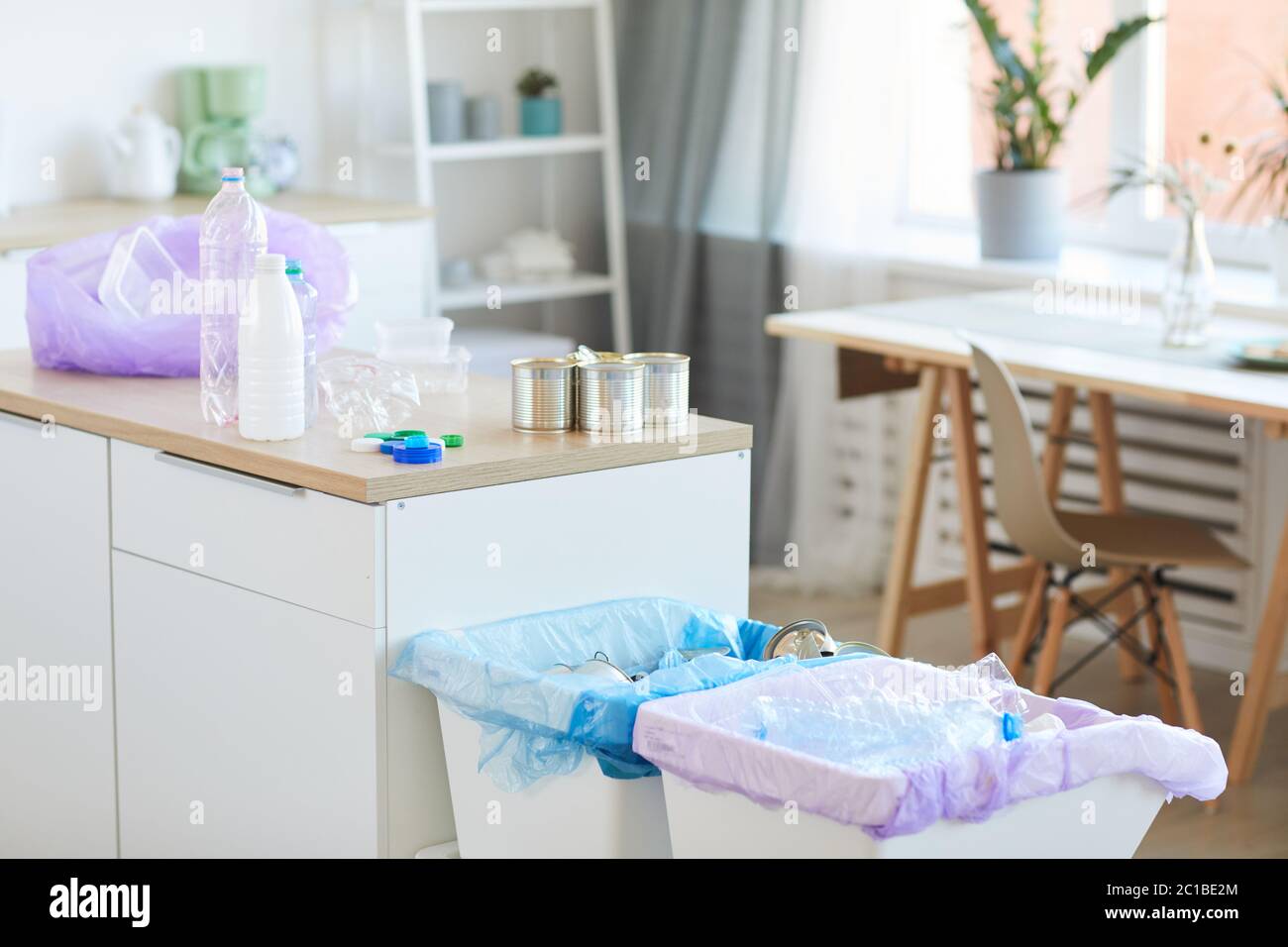 Image of plastic bottles cans and other garbage on the table being ...