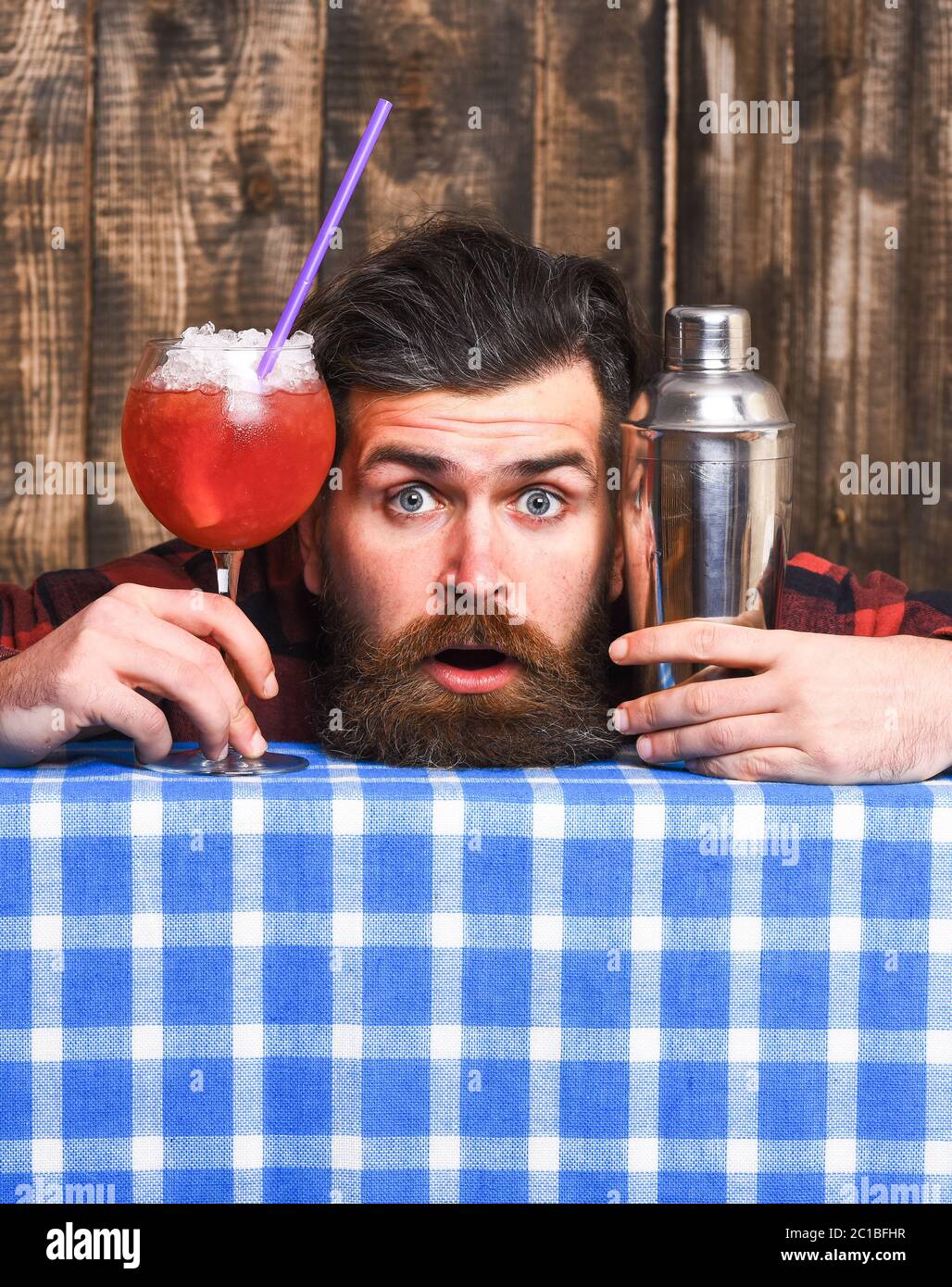 Cocktails and alcohol concept. Barman with beard and surprised face put ...