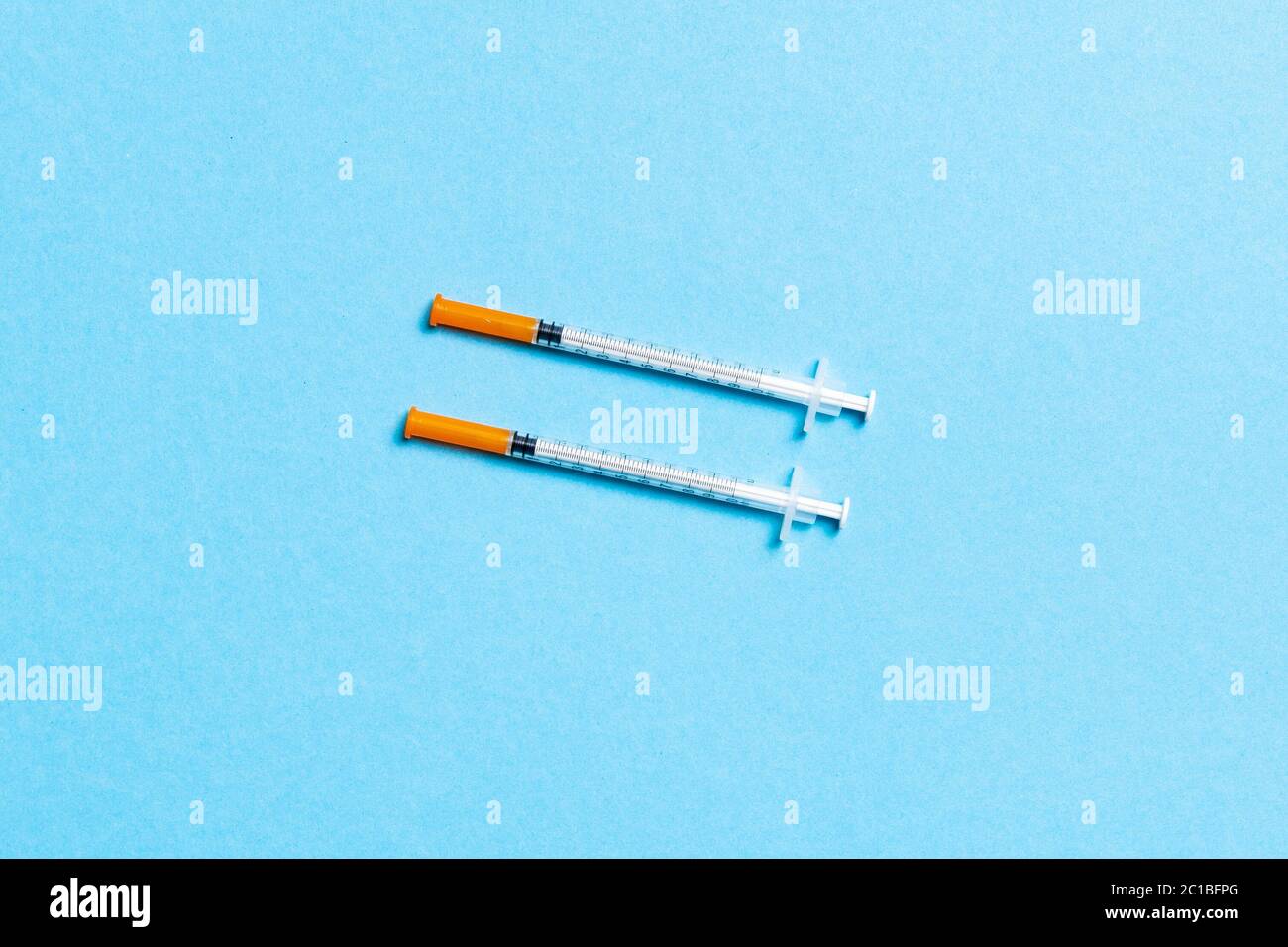 Top view of insulin syringes in a row for medical injection on colorful ...