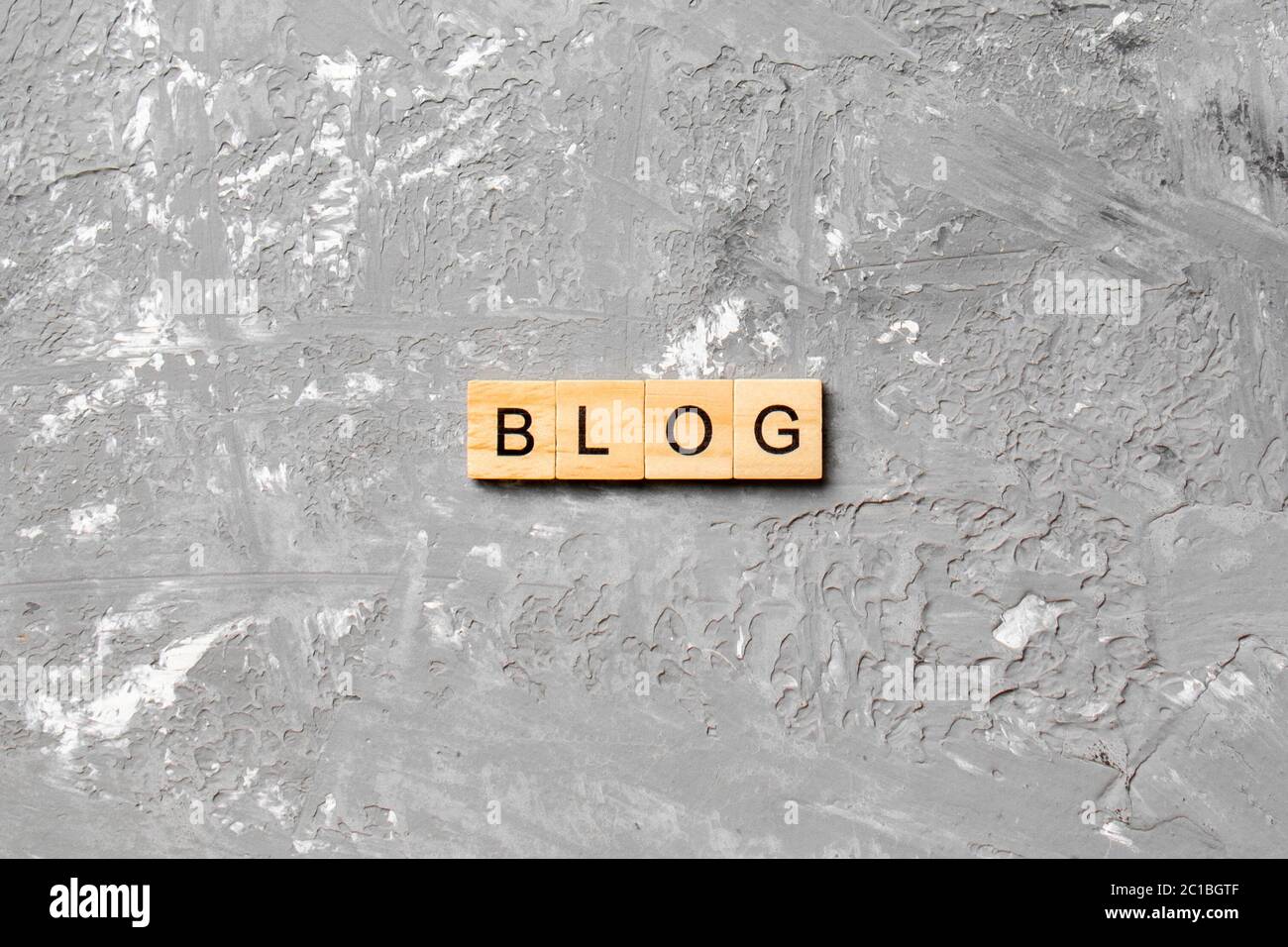 BLOG word written on wood block. BLOG text on cement table for your ...