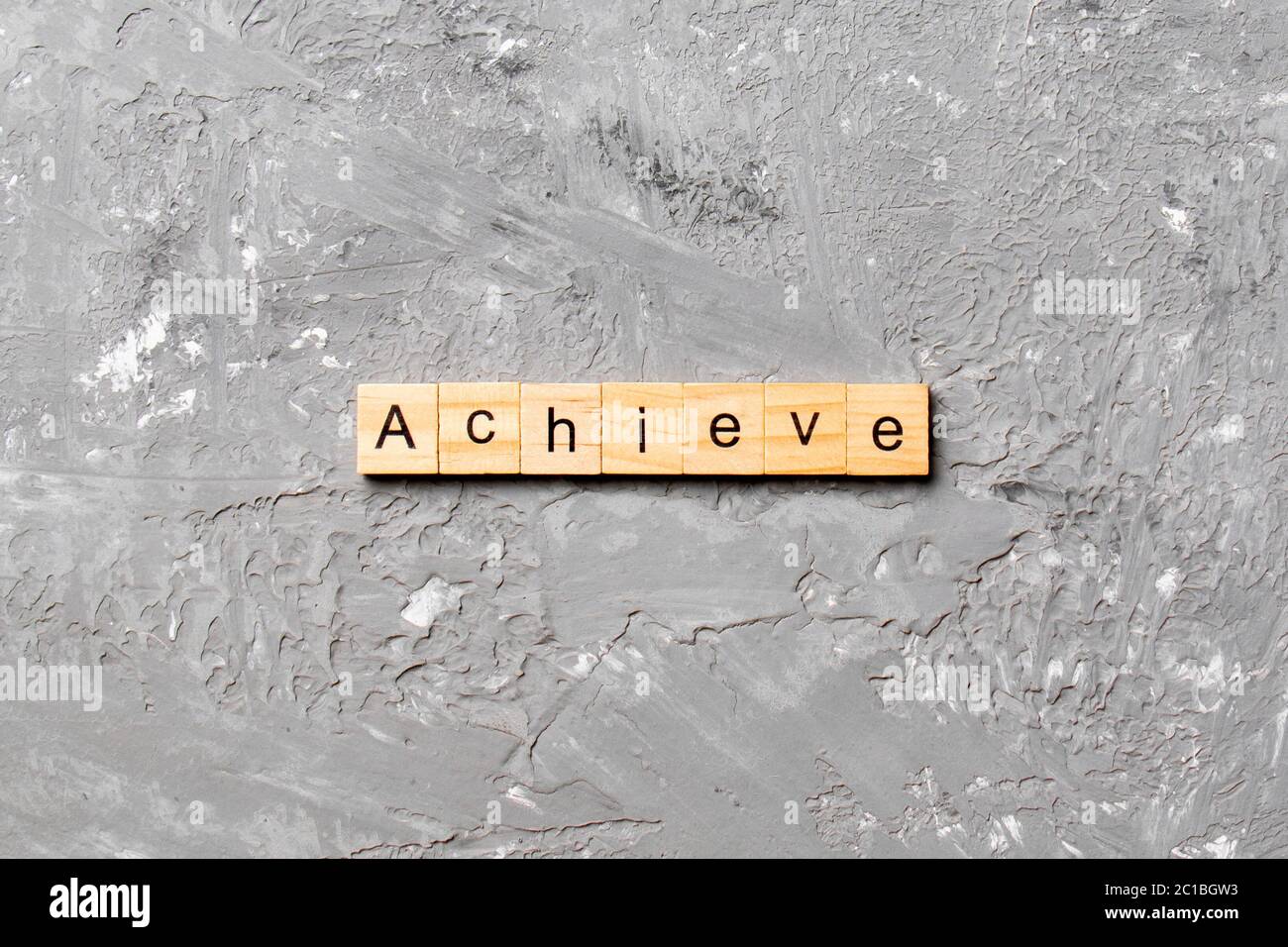 Achieve word written on wood block. Achieve text on cement table for ...