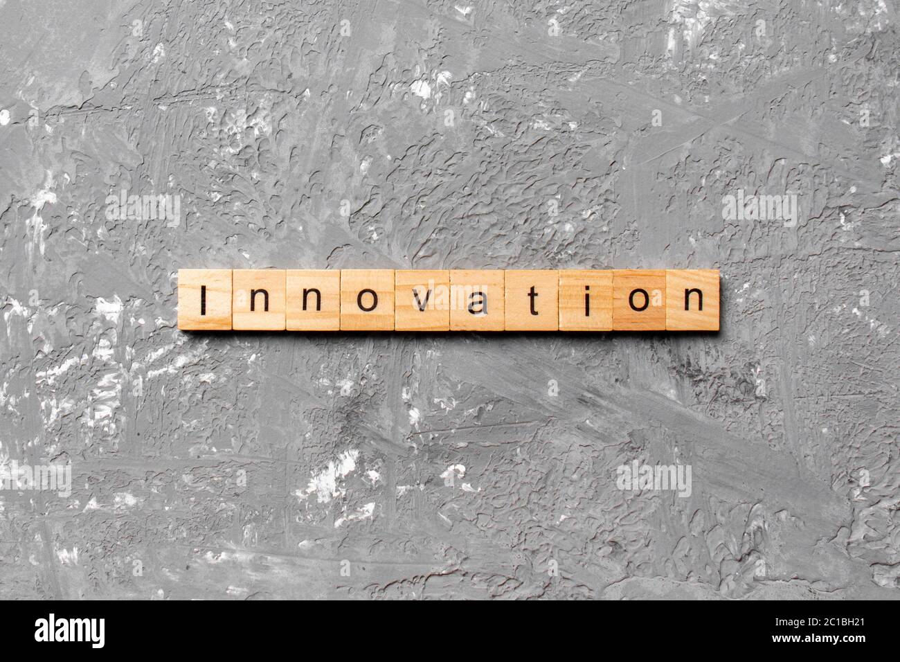 INNOVATION word written on wood block. INNOVATION text on table ...
